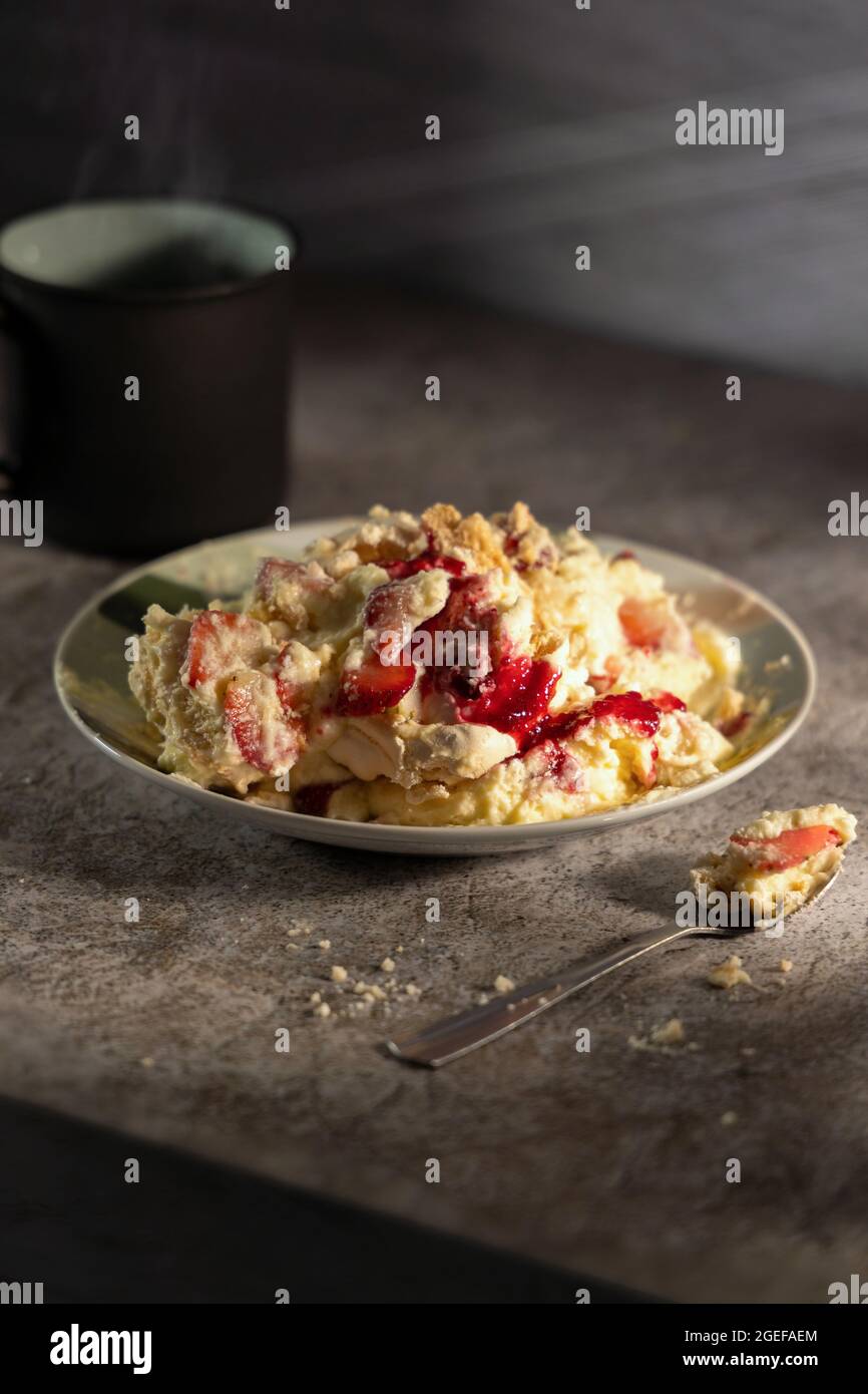 Vertical shot of delicious strawberry meringue dessert on a plate, on a ...