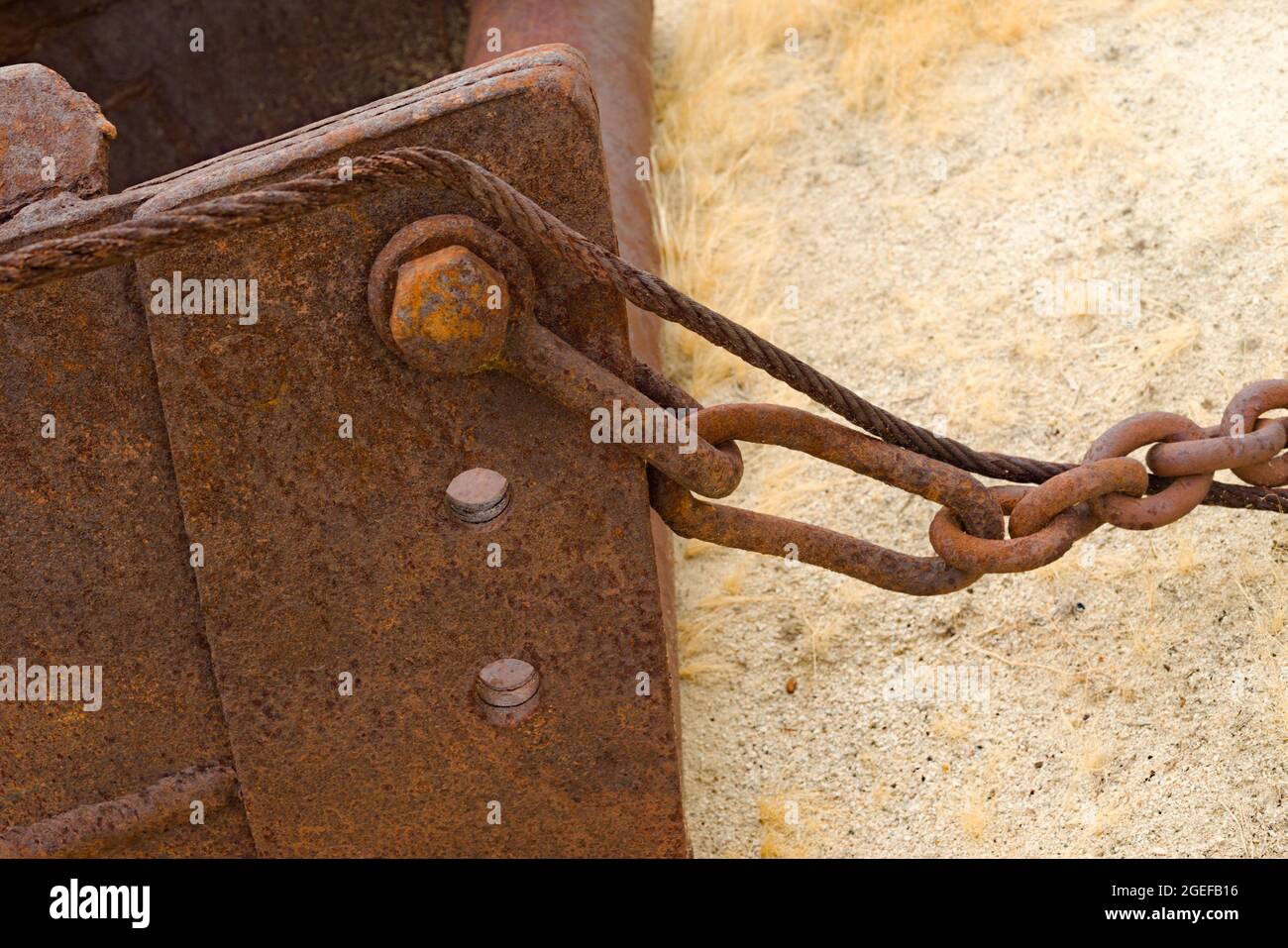 Abstract showing the details of chain bolted to an older used rusty ...