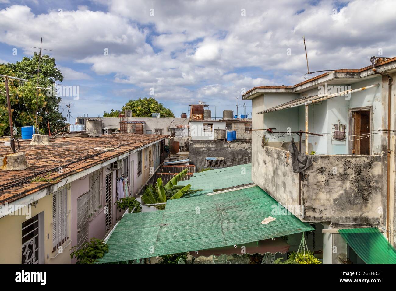 Block of old dirty buildings with balconies under a blue cloudy sky ...