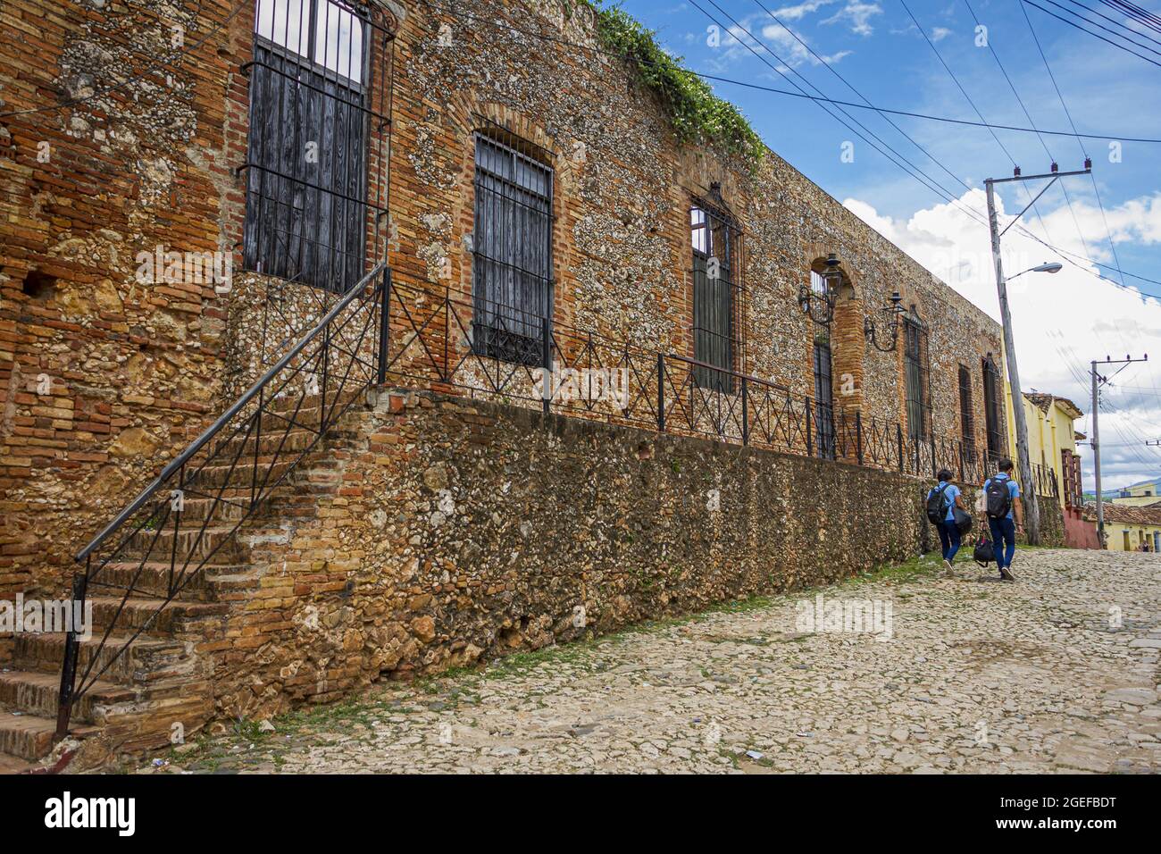 Old stone building with a staircase under a blue cloudy sky in Cuba ...