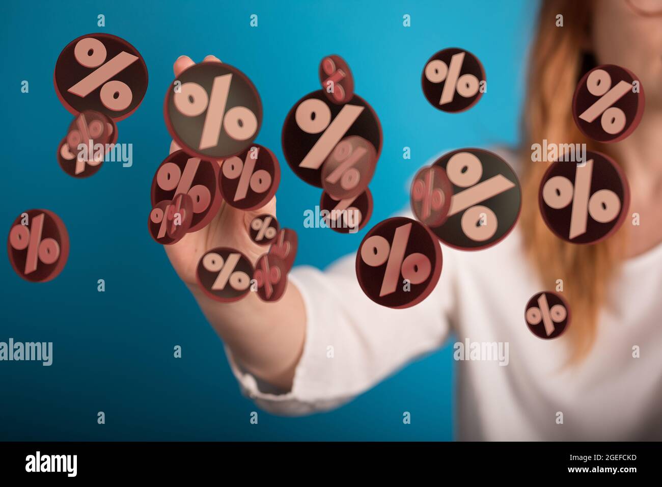 Businesswoman selecting from a 3D render of floating percentage symbols ...