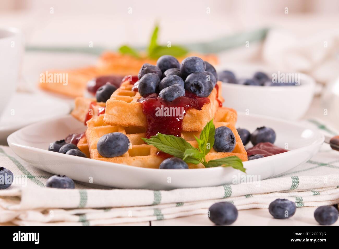 Waffles with blueberries and jam Stock Photo - Alamy