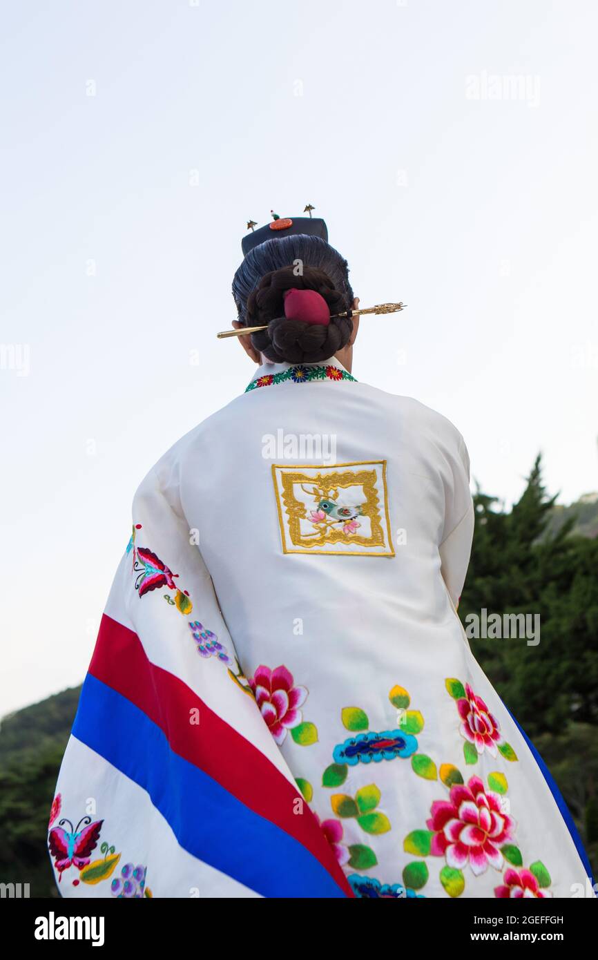 Back view of a female wearing a traditional hanbok with colorful ...