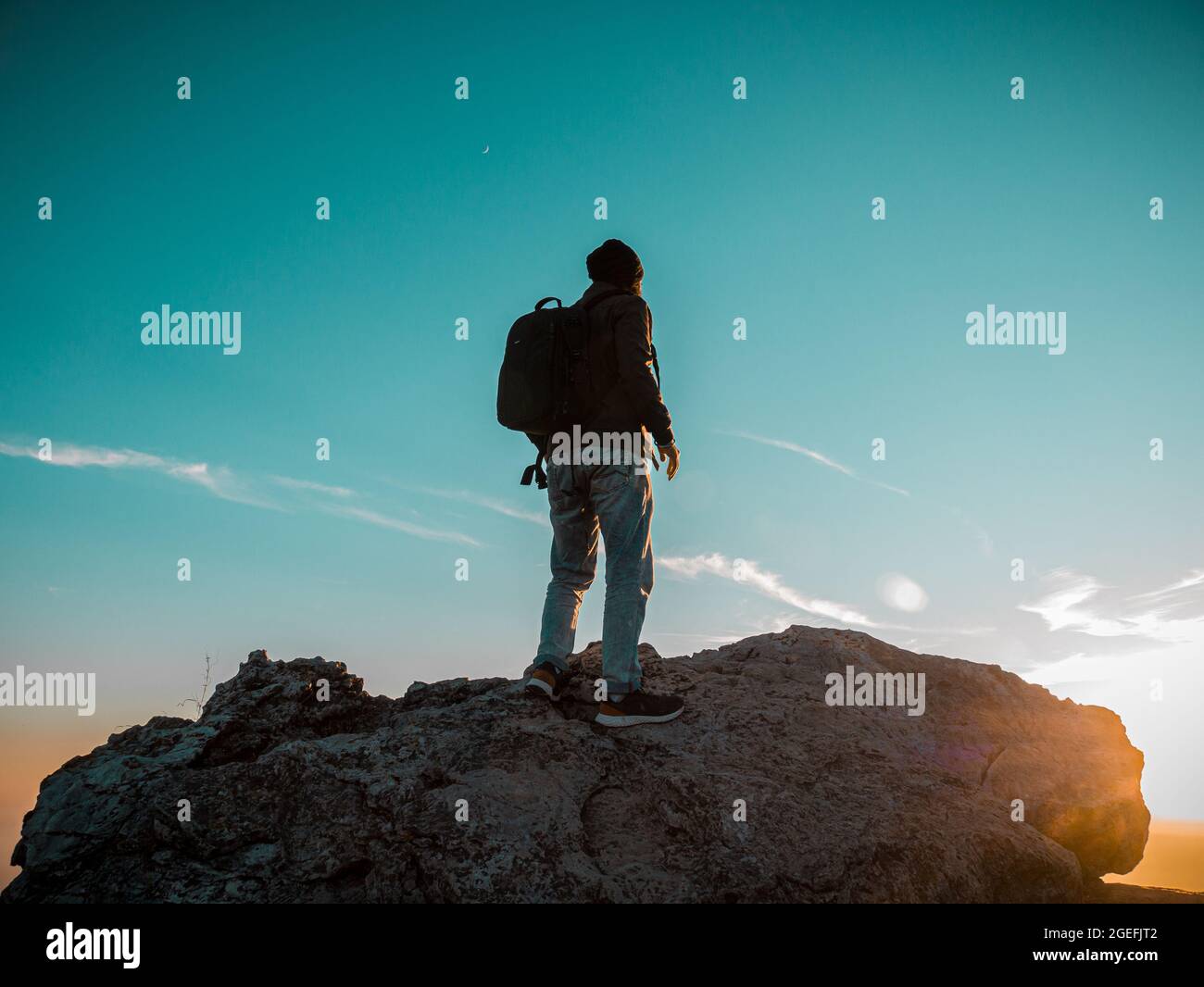 Young hiker standing on a rock and observing the beautiful view Stock ...