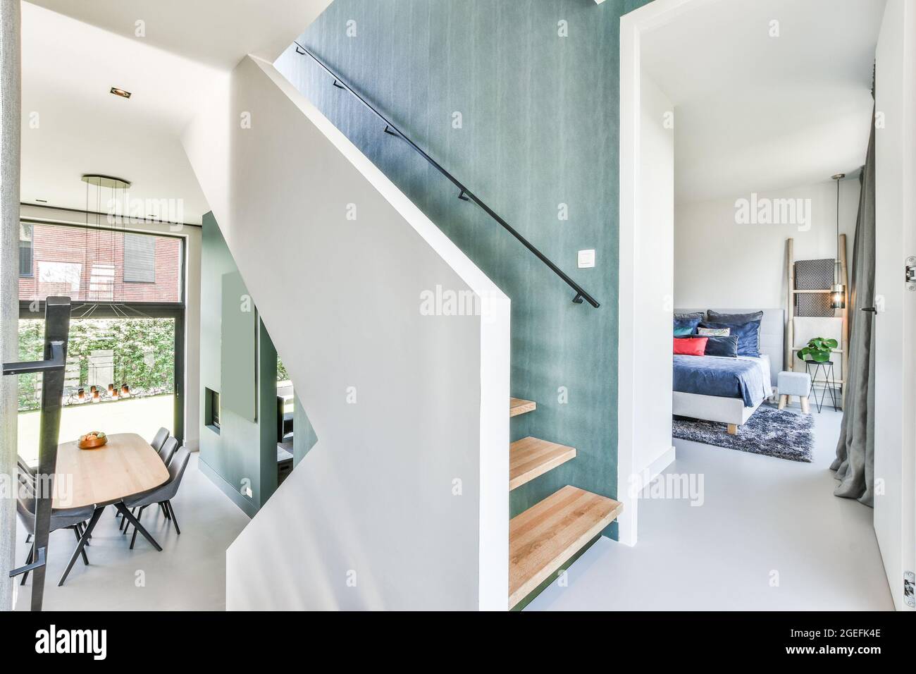 Modern apartment interior with a staircase leading to the second floor ...