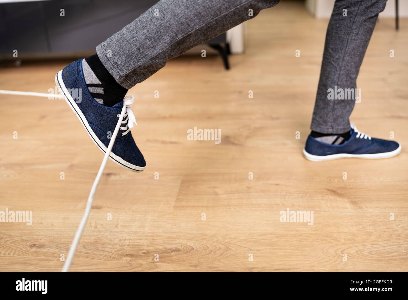 Trip Over Wire Cable. Fall On Office Floor Stock Photo - Alamy
