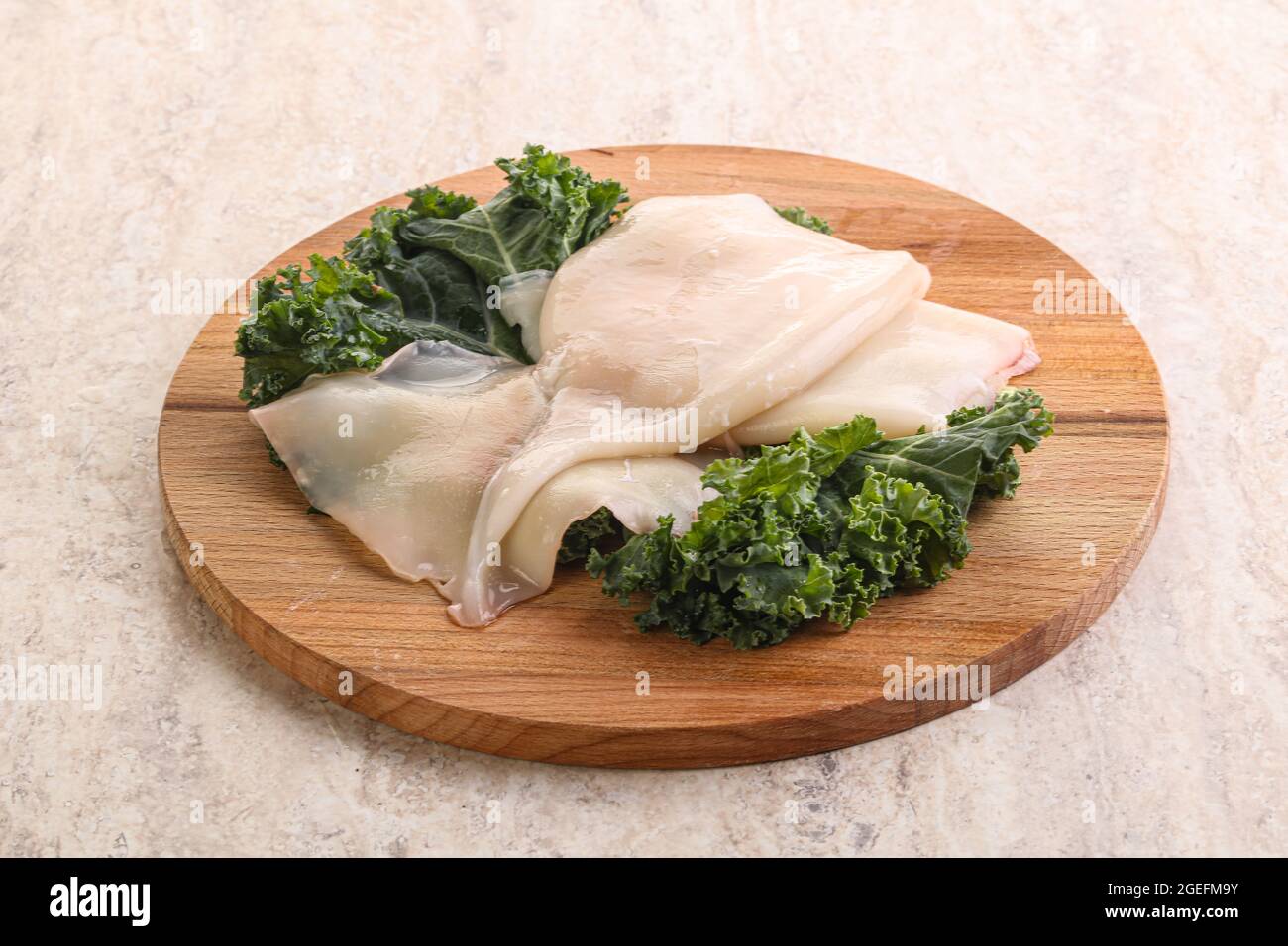 Raw squid over wooden board for cooking Stock Photo - Alamy
