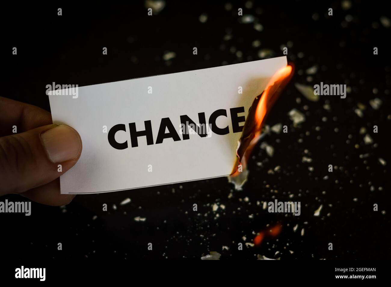 burning chance, human hand holding the word chance written on a paper ...