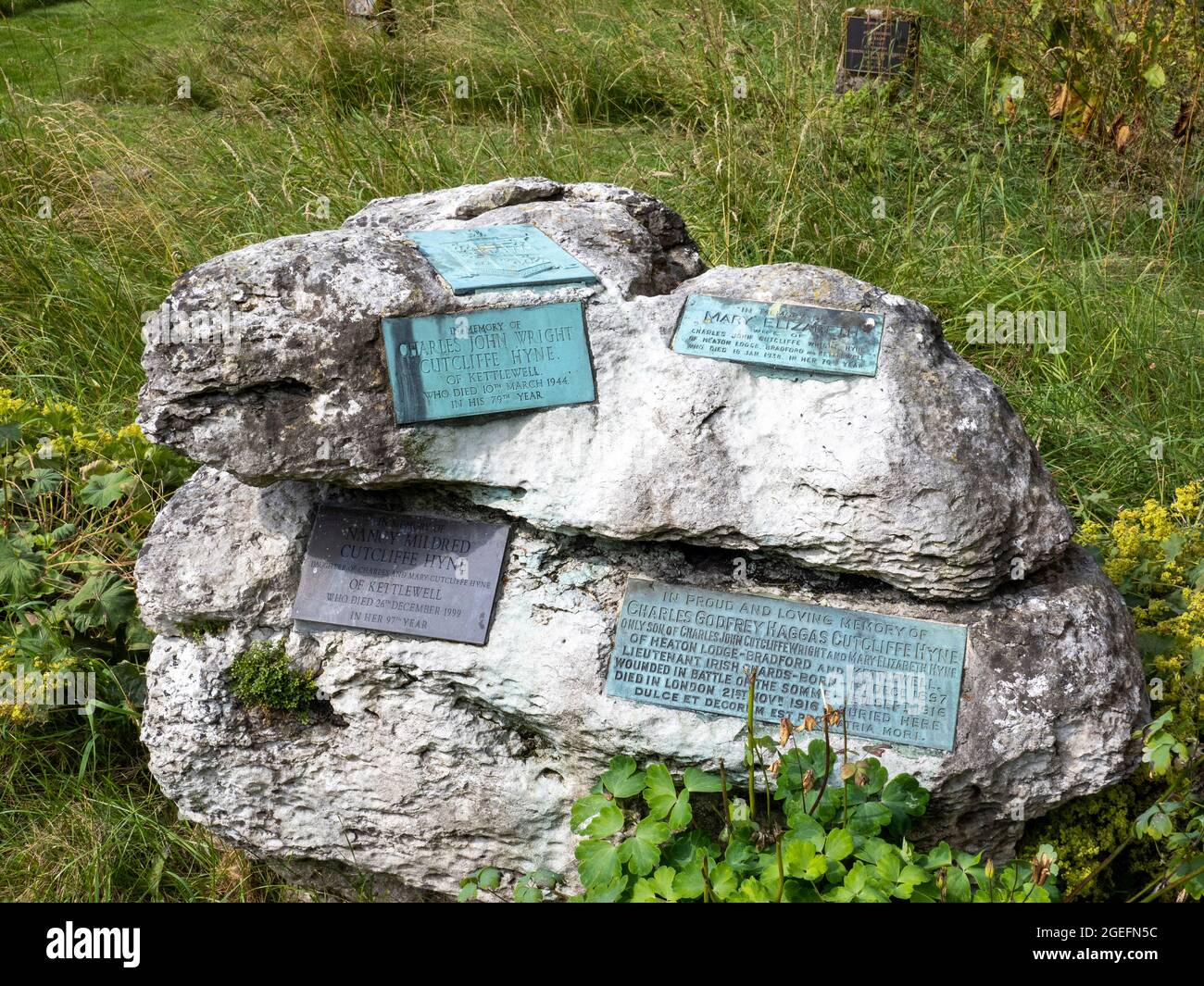 Memorial plaques on a limestone boulder in Kettlewell Churchyard ...