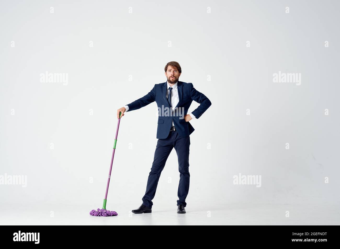 business man in a suit with a mop in his hands cleaning service Stock ...