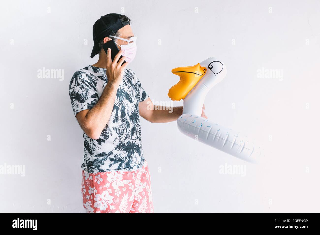 Young man wearing mask to protect himself from covid-19 on vacation ...