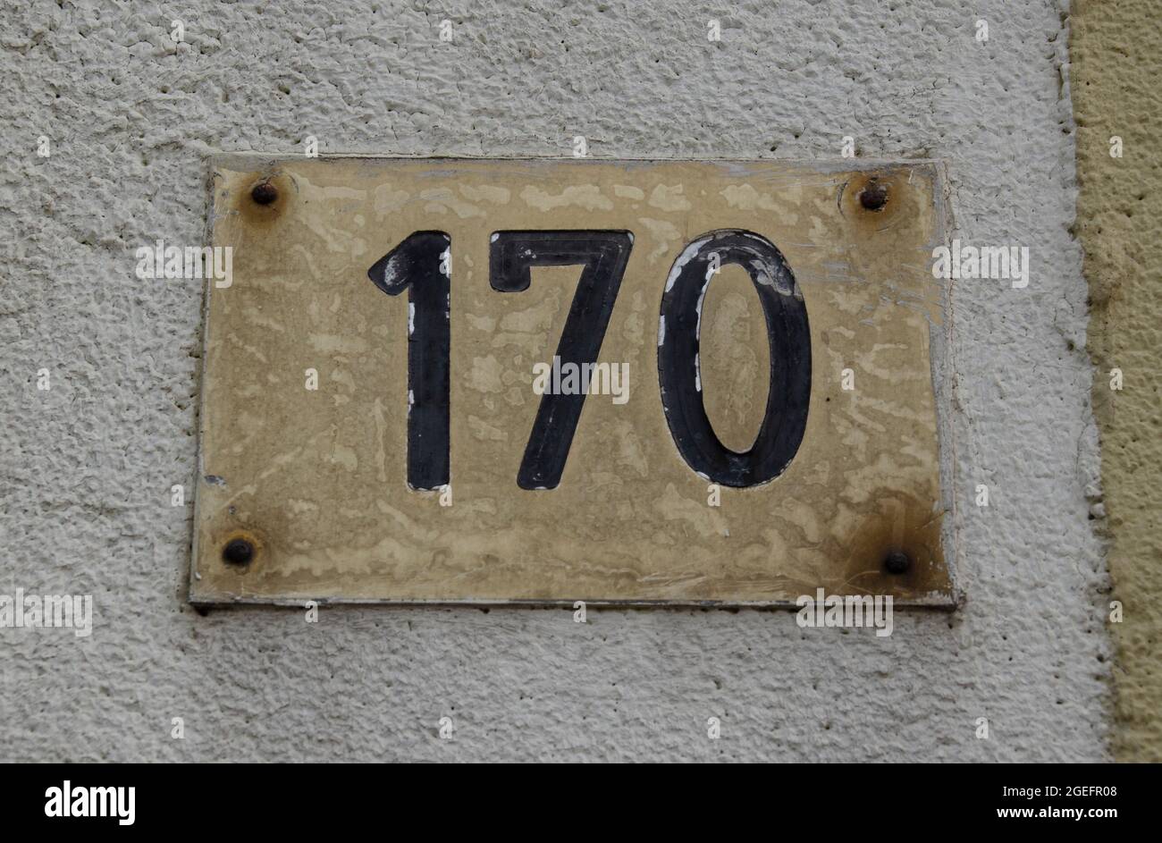 A sign on a wall with the number Stock Photo - Alamy