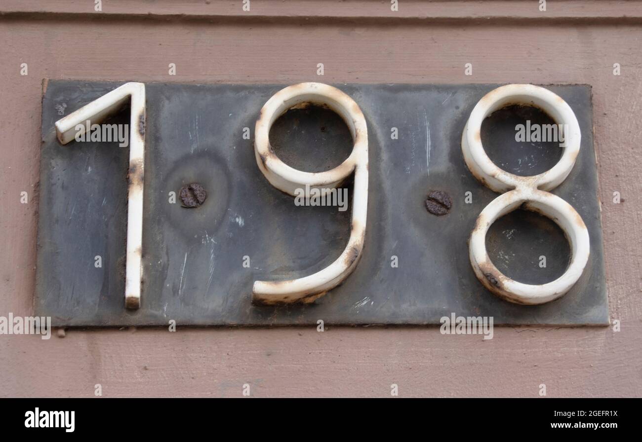 A sign on a wall with the number Stock Photo - Alamy