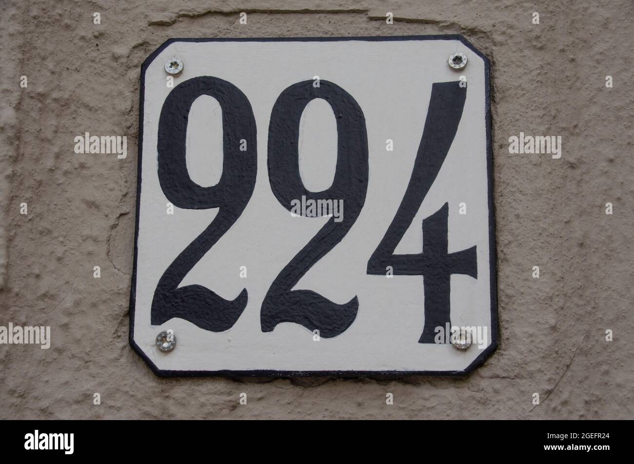 A sign on a wall with the number Stock Photo - Alamy