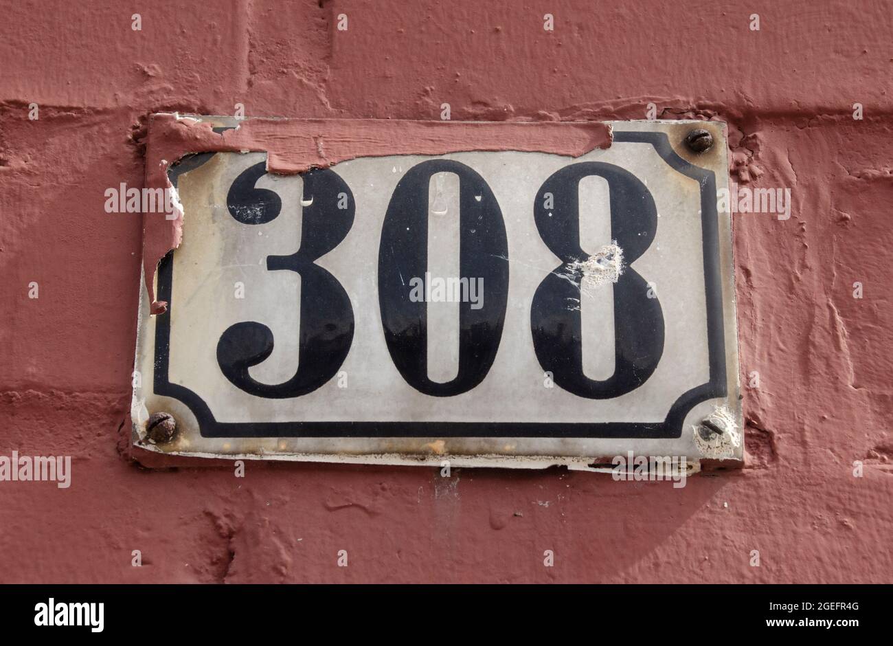 A sign on a wall with the number Stock Photo - Alamy