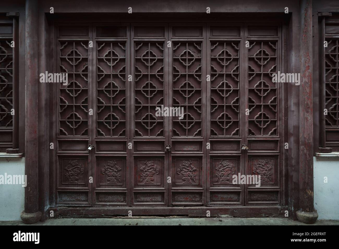 The dark brown ancient wooden door panel built in traditional Chinese ...