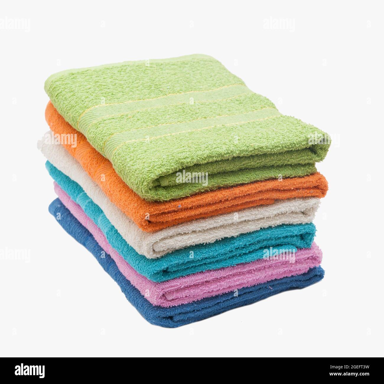 Stacked multicolored towels on white background Stock Photo - Alamy