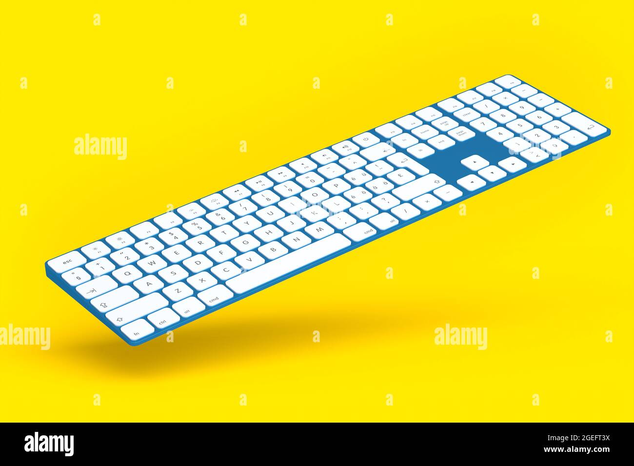 Modern blue aluminum computer keyboard with numpad isolated on yellow ...