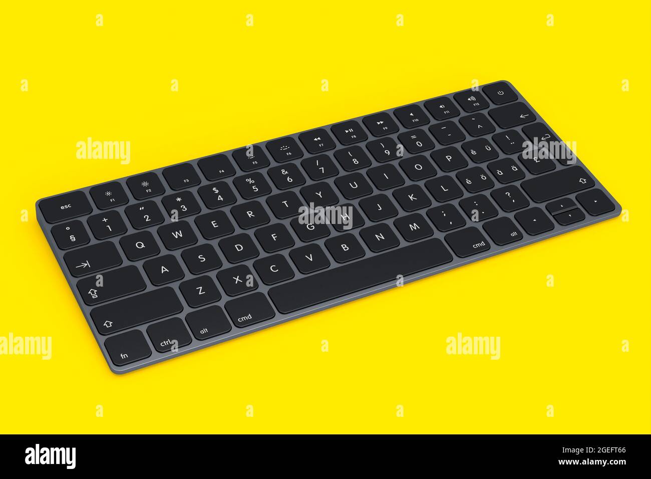 Modern dark aluminum computer keyboard isolated on yellow background ...