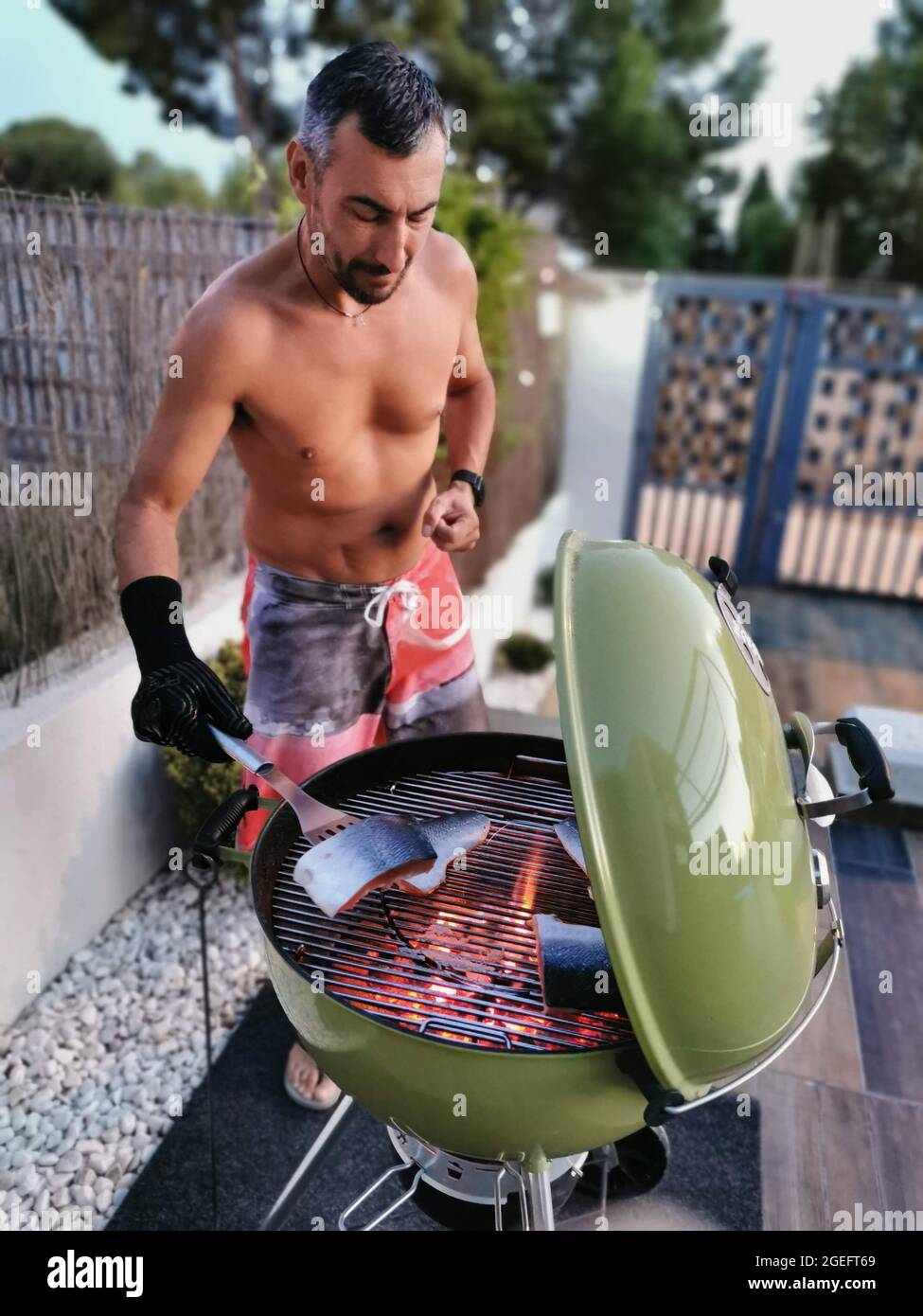 Hispanic man from Spain preparing grill Stock Photo - Alamy