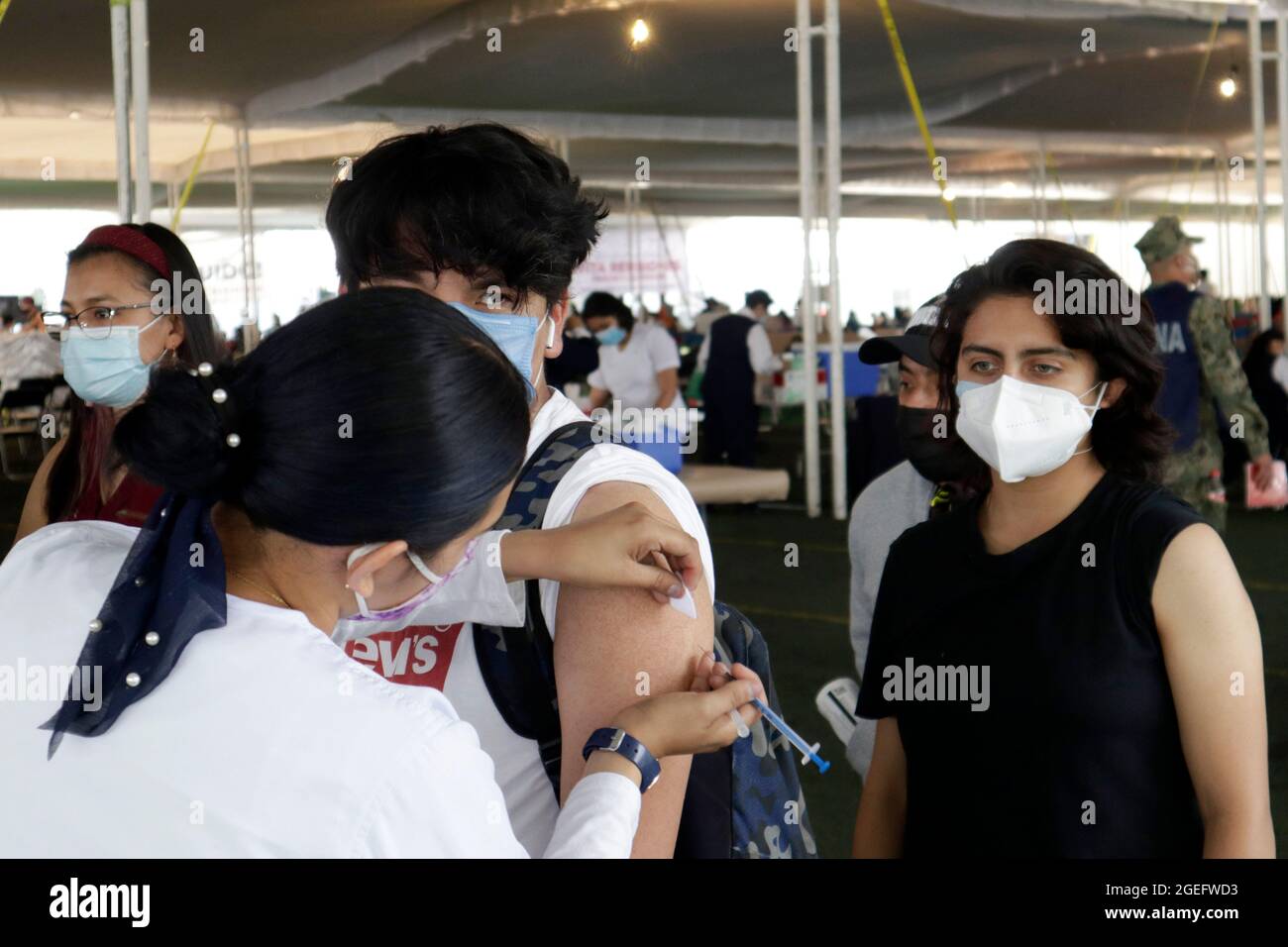 Non Exclusive: MEXICO CITY, MEXICO - AUGUST 19: A teenager receives the ...