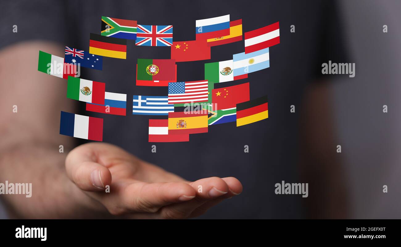 Hand holding from a floating network of international flag symbols ...