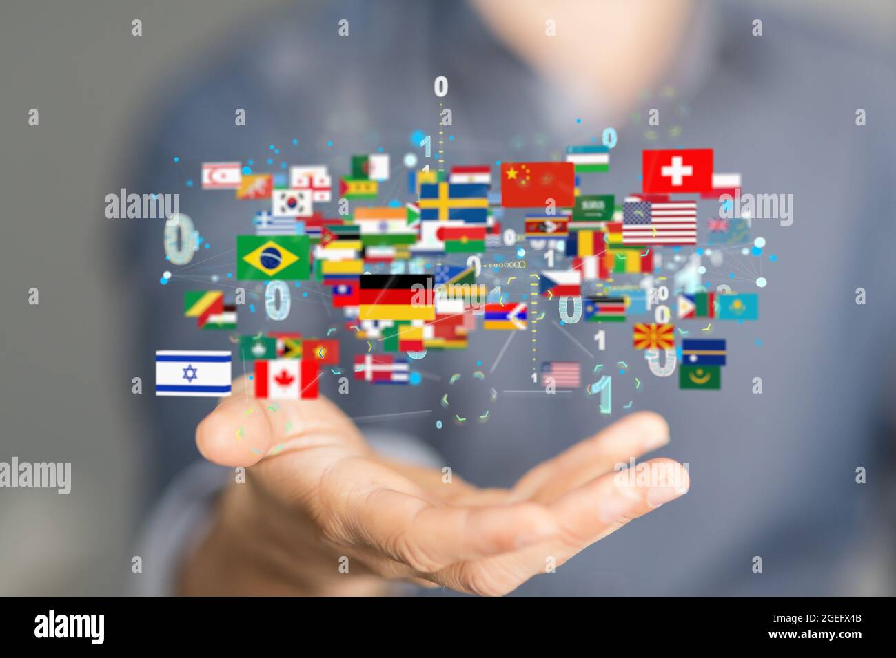 Hand holding from a floating network of international flag symbols ...