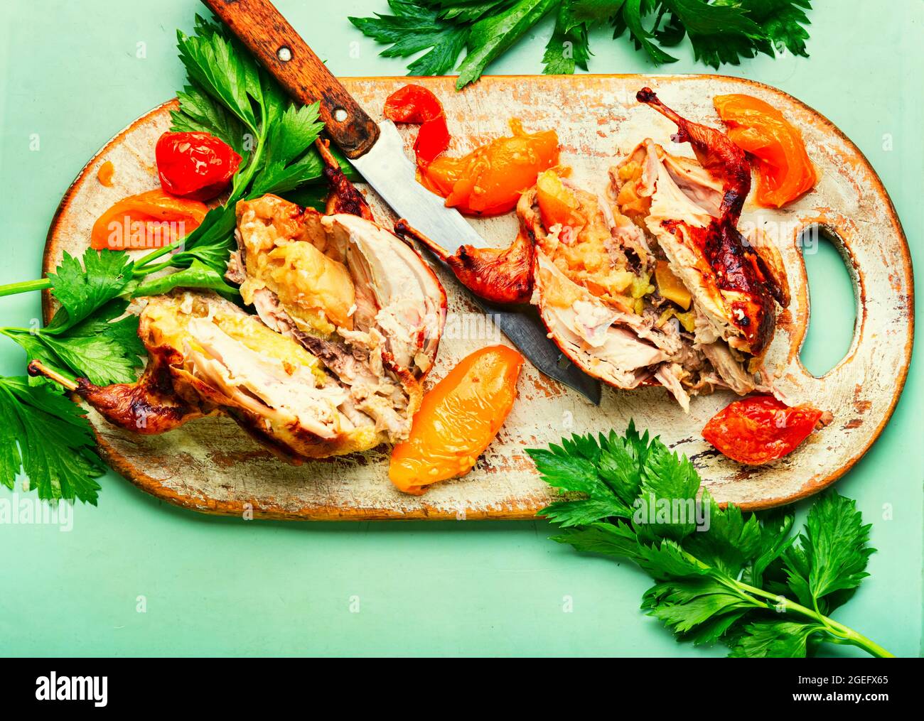 Cut quails baked in tomato sauce. Stewed quails on a cutting board ...