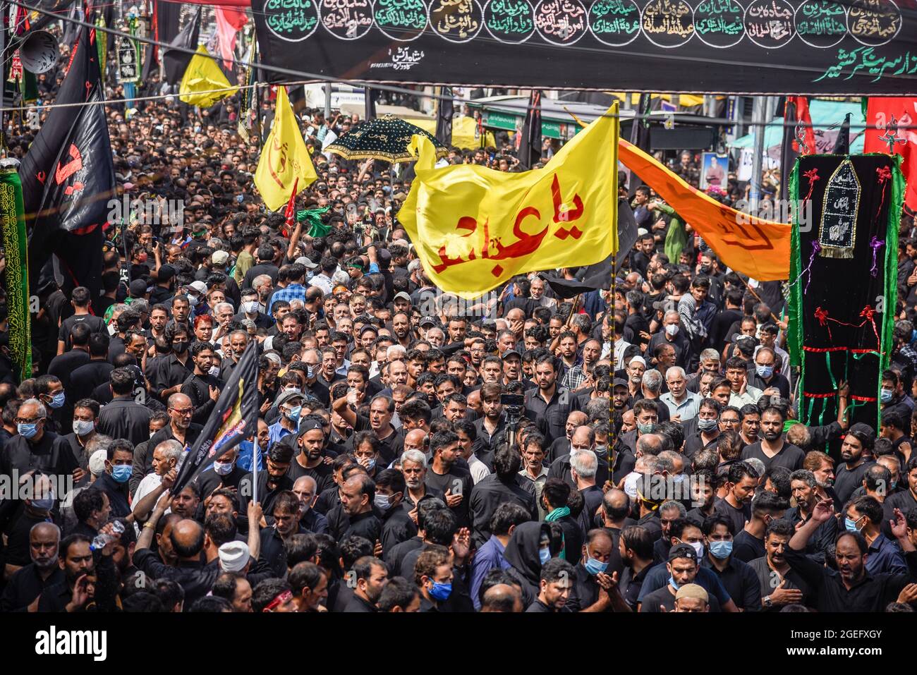 Kashmiri Shia Muslims wave flags as they take part during the Ashura ...