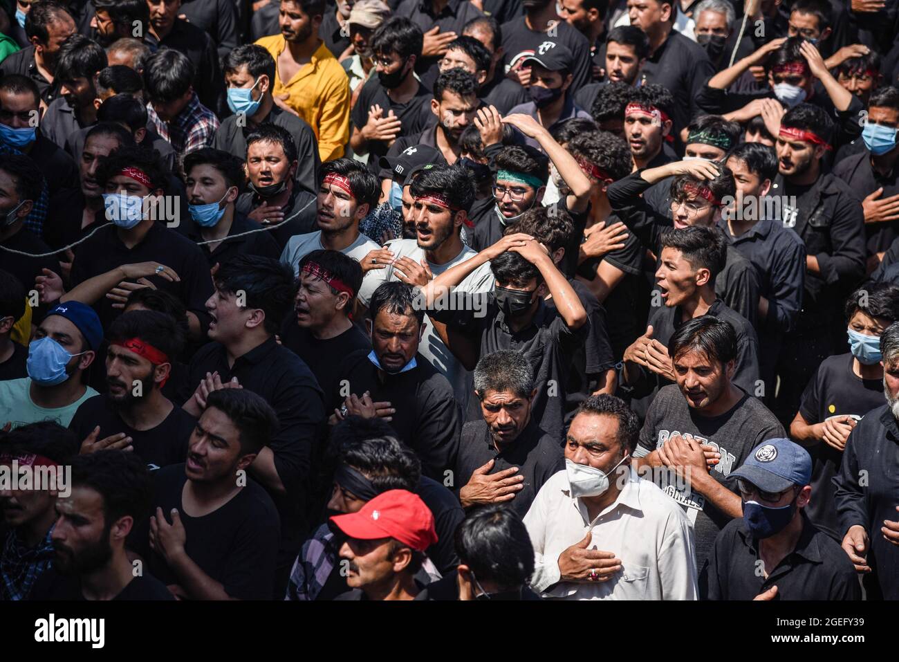 Kashmiri Shia mourners beat their chests as they take part during the ...