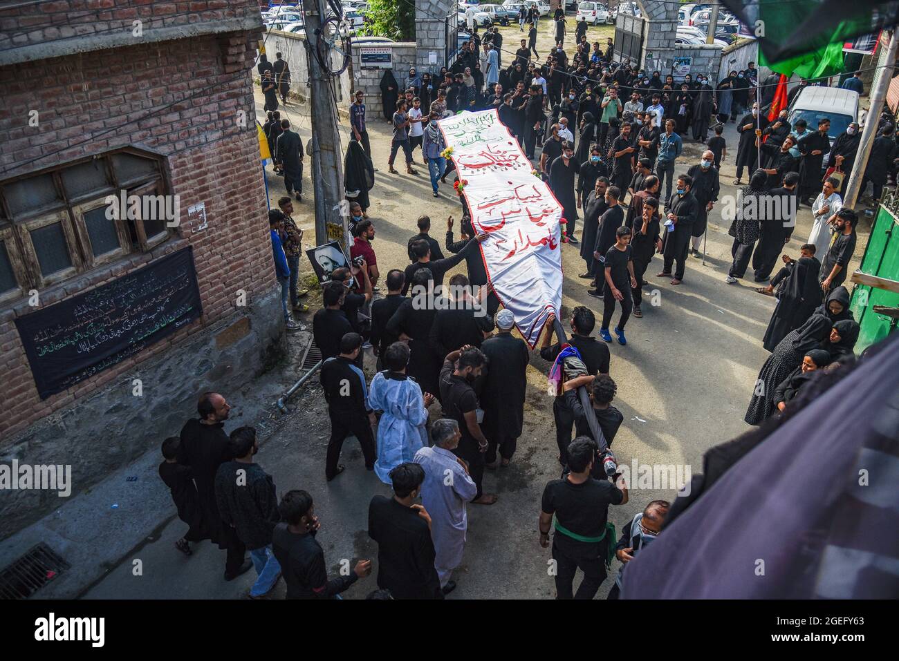 Kashmiri Shia Muslims carry a religious flag during the Ashura ...