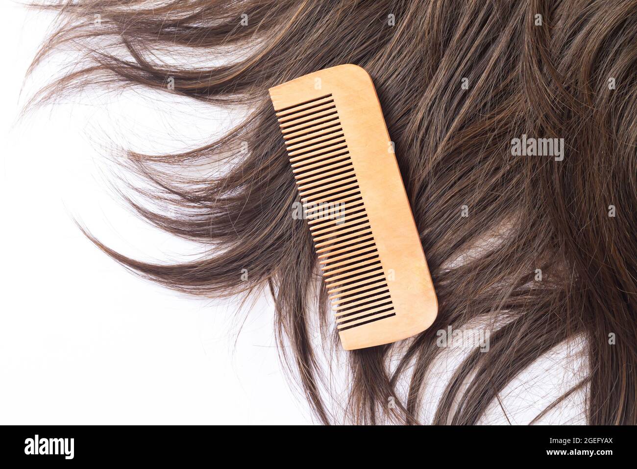 Straight brown hair with wooden comb isolated on white background top ...