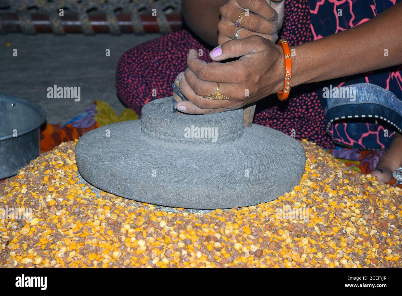 Grindstone woman flour hi-res stock photography and images - Alamy
