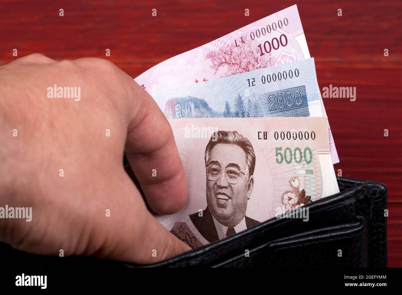 North Korean money - won in the black wallet Stock Photo - Alamy