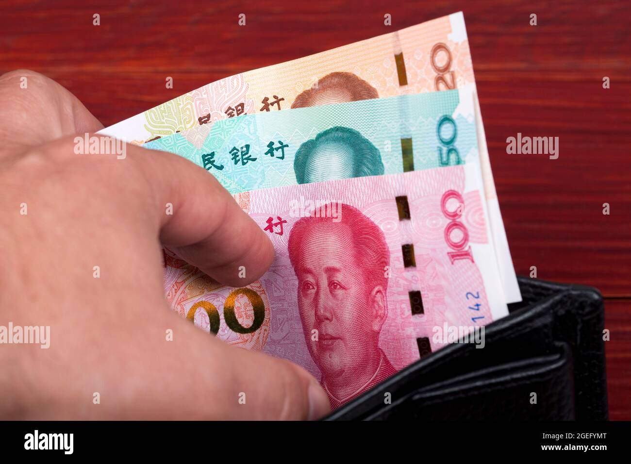 Chinese money in the black wallet Stock Photo - Alamy