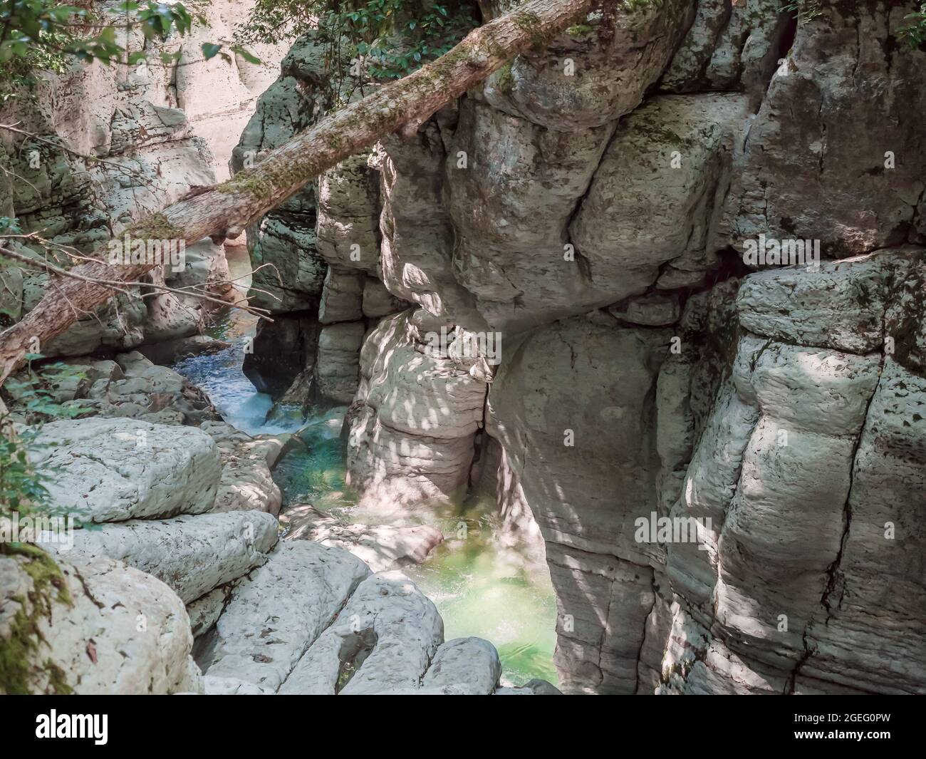Steep smooth relief canyons with river flowing into their gorge ...