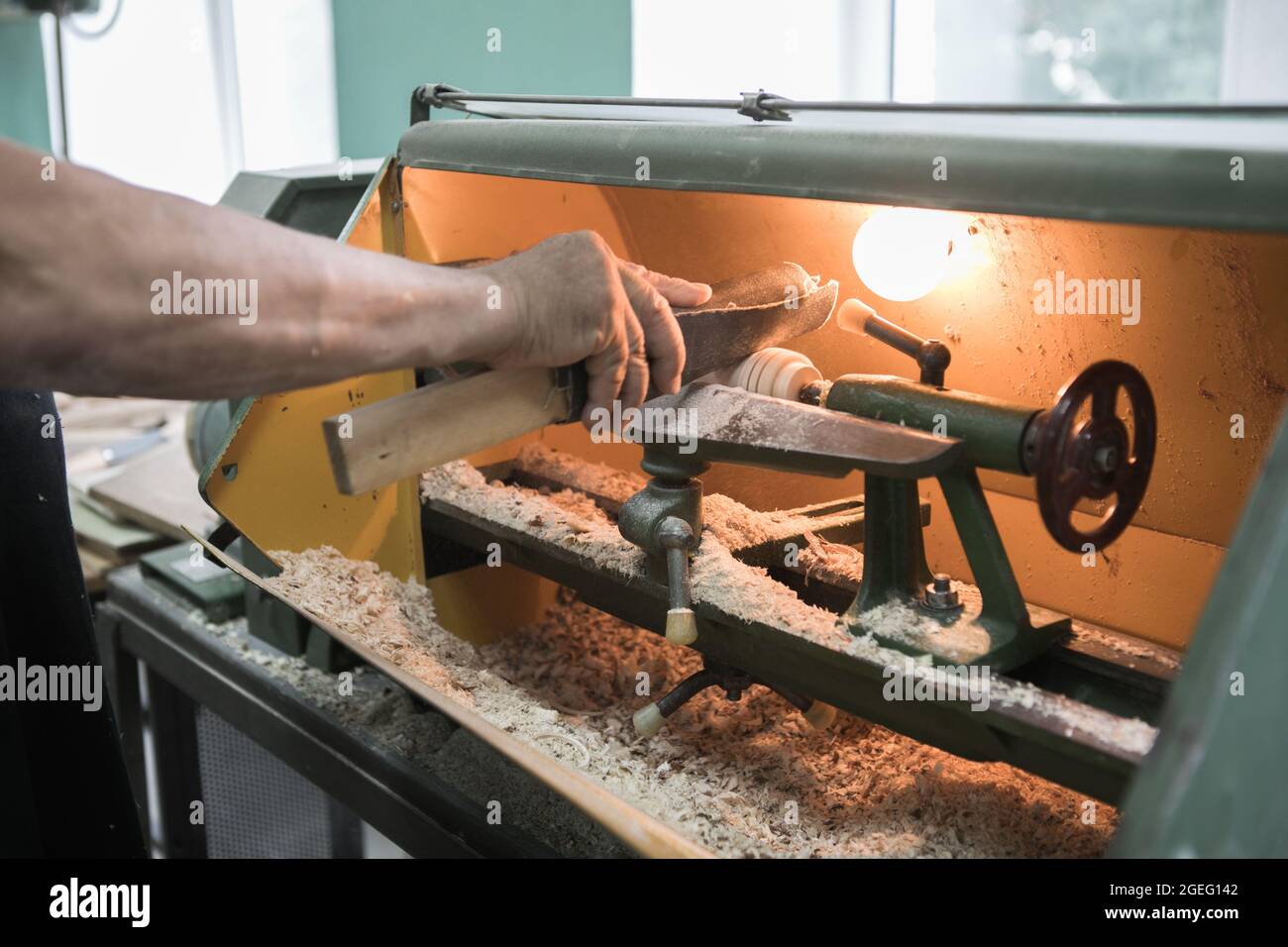 Turning a wooden part on a lathe. Joinery. Carpentry work. Mechanical ...