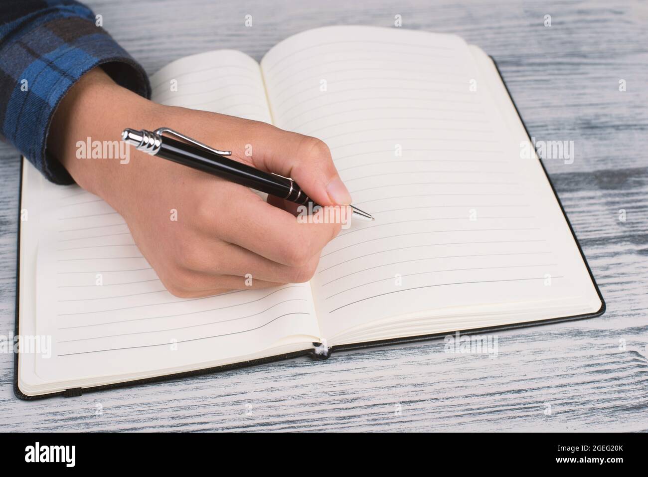 Writing into a book, empty copy space for text, hand with a pen Stock ...