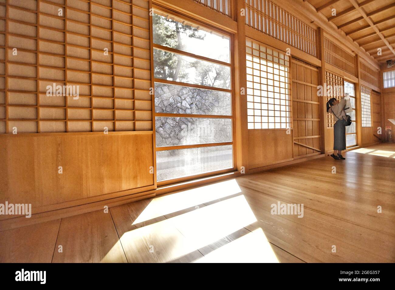 View of a Japanese female shooting by camera inside big wooden ...