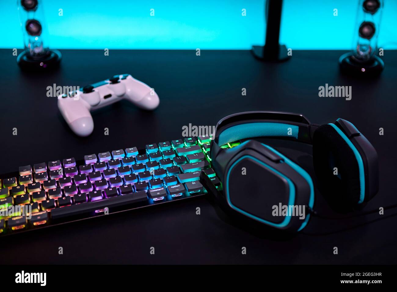 Various color backlighted gaming accessories on grey desk. Cyan ...