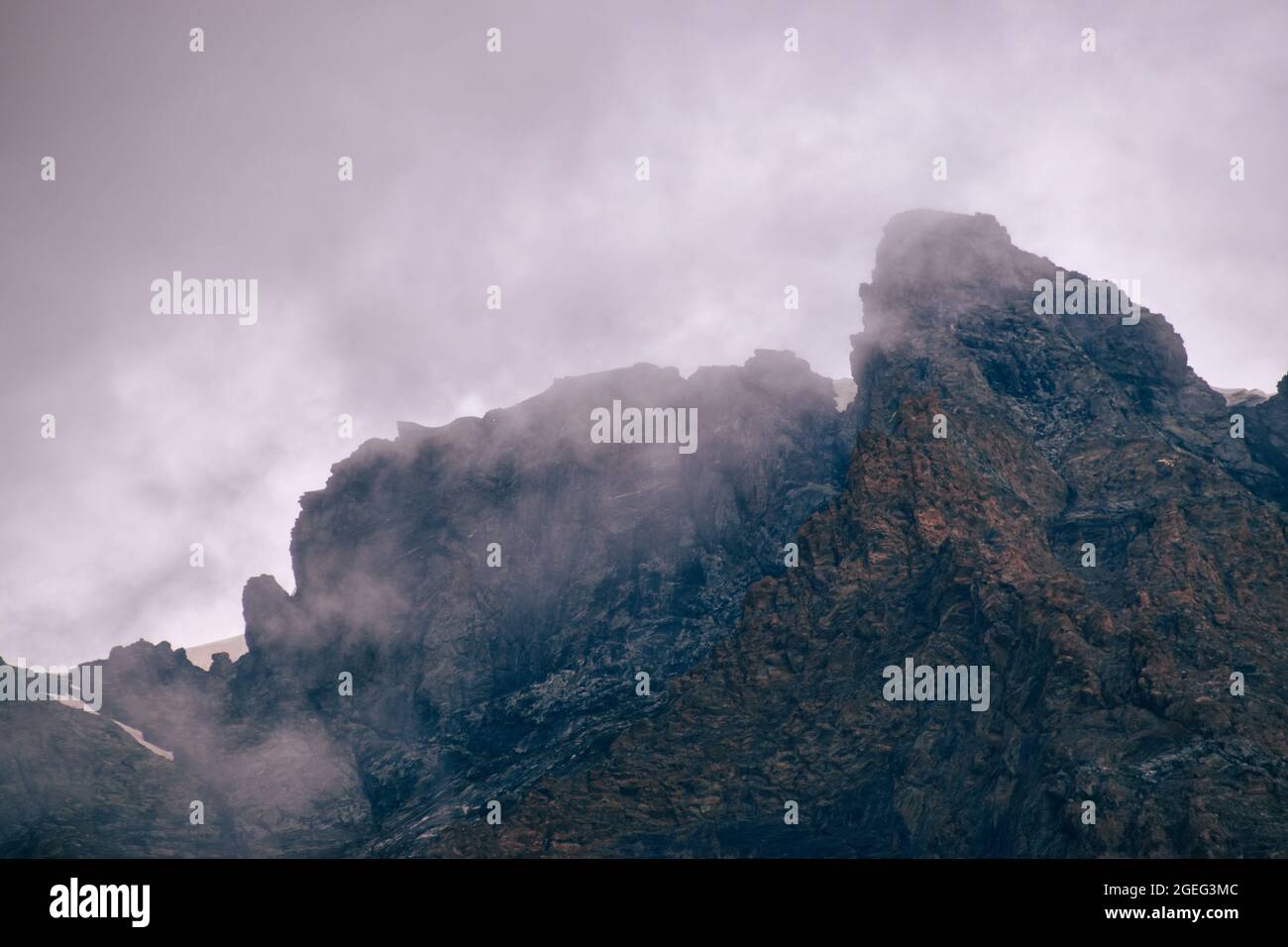 Rocks covered by dense fog in the Gran Paradiso National Park in ...