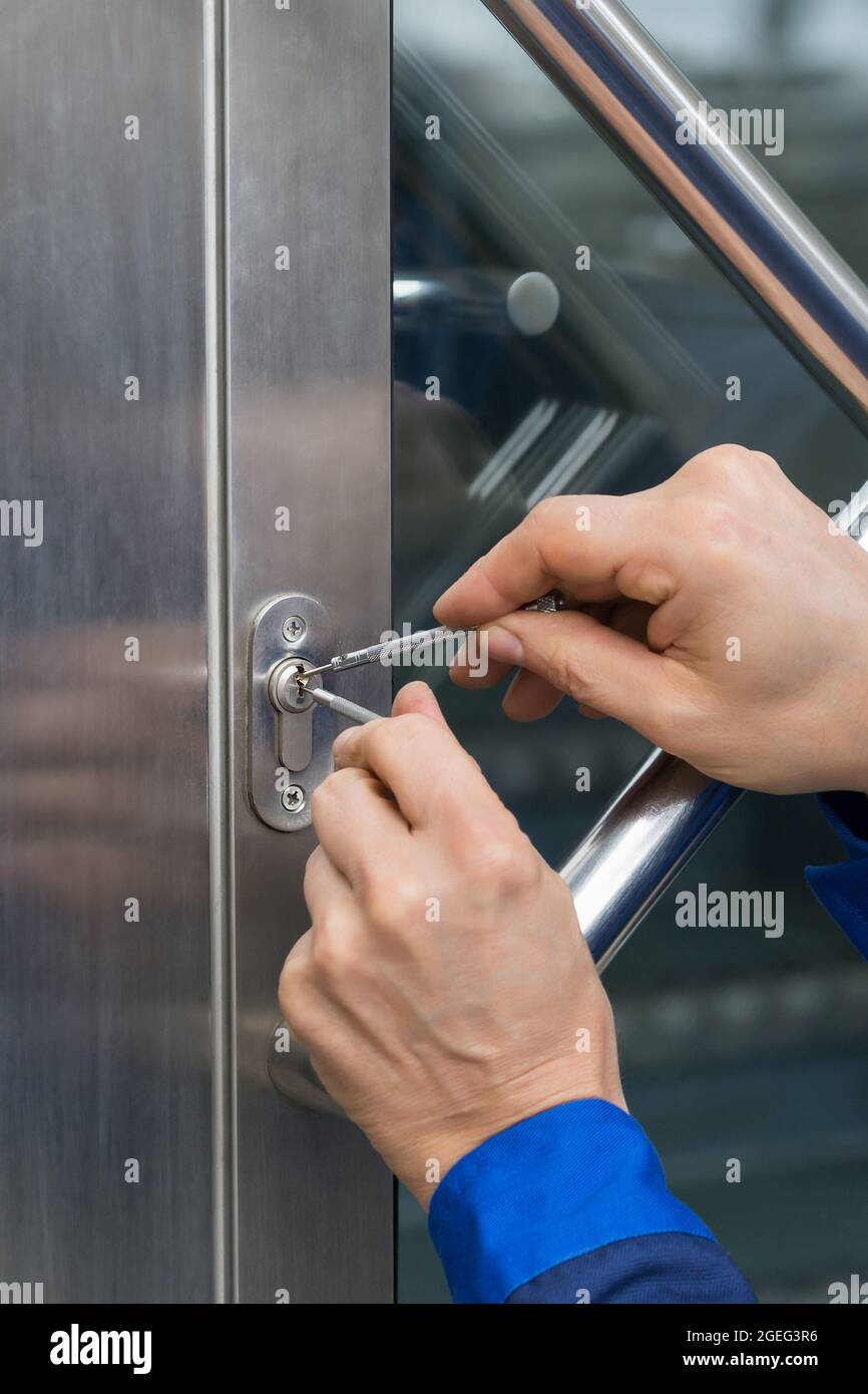 Locksmith Workman Repairing Lock. Lockpicker Worker At Door Stock Photo ...