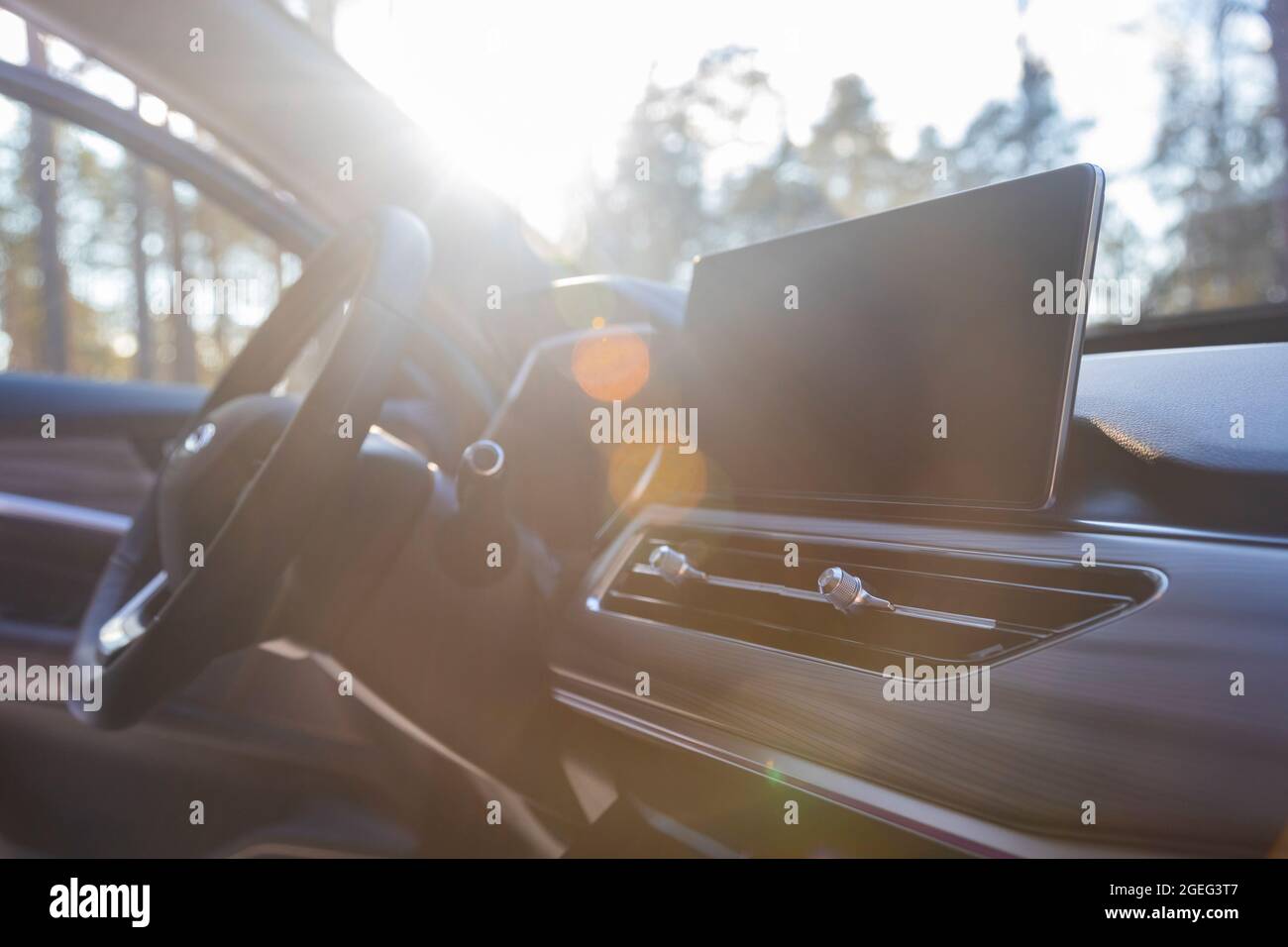 interior of modern luxury car in sunshine. monitor, airduct and ...