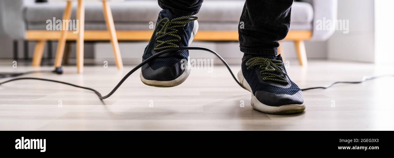 Wire Cord Trip Over And Fall. Feet Stumble On Cable Stock Photo - Alamy