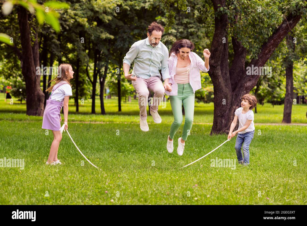 Photo of charming funky family dressed casual outfit playing jumping ...