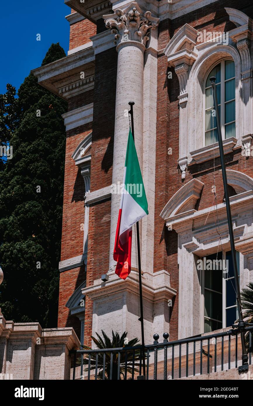 Vertical shot of the Italian flag in front of a building in Rome Stock ...