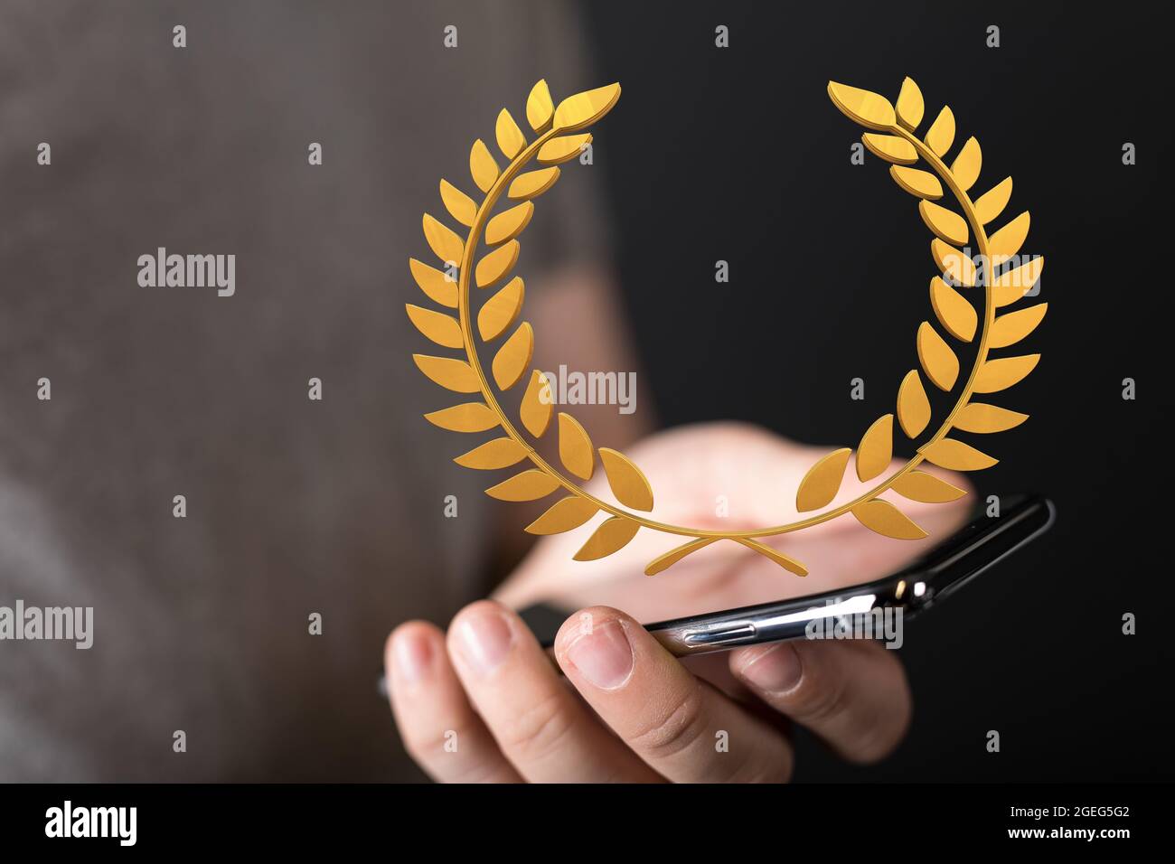 3D rendered golden laurel wreath held in person's hand Stock Photo - Alamy
