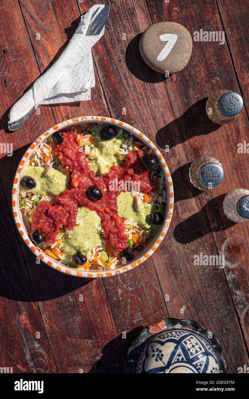 Top view closeup of a typical Moroccan food bowl, utensils and a stone ...