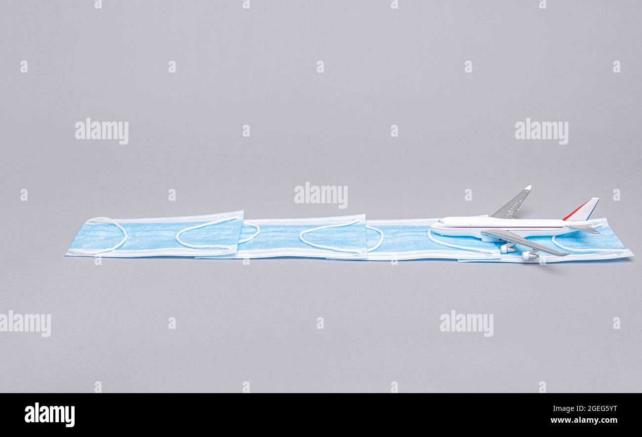 Airplane model and mask. COVID-19 Stock Photo - Alamy