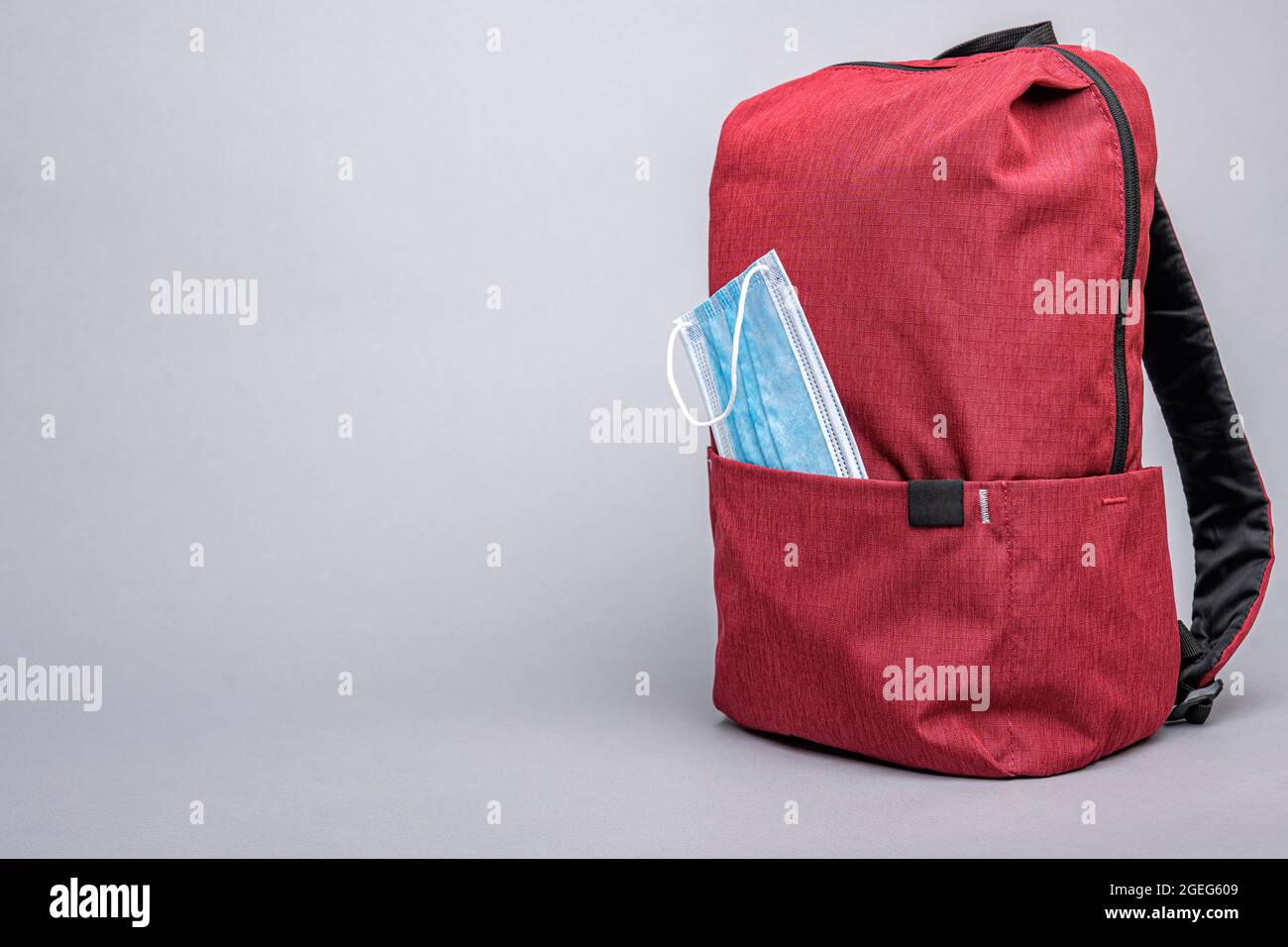 The mask is in the pocket of the backpack Stock Photo - Alamy